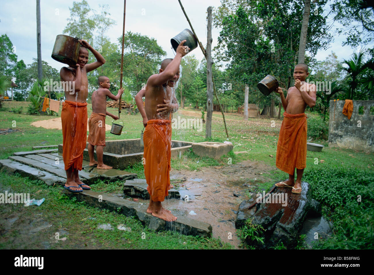 Novice monks washing in the evening near Roulos Temple Angkor Wat Siem ...