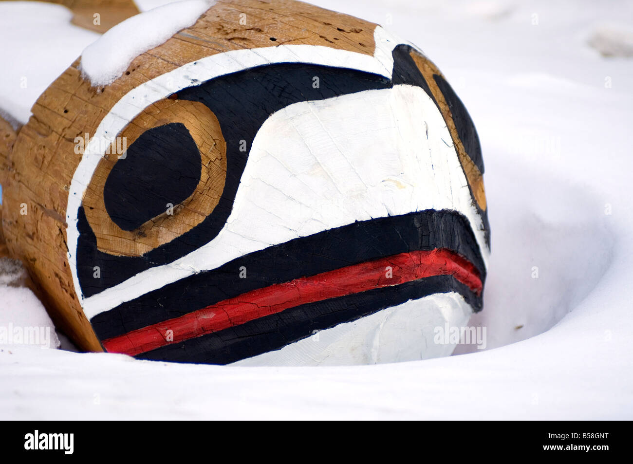 First nation carved bench in snow, Banff, Alberta Canada, North America ...
