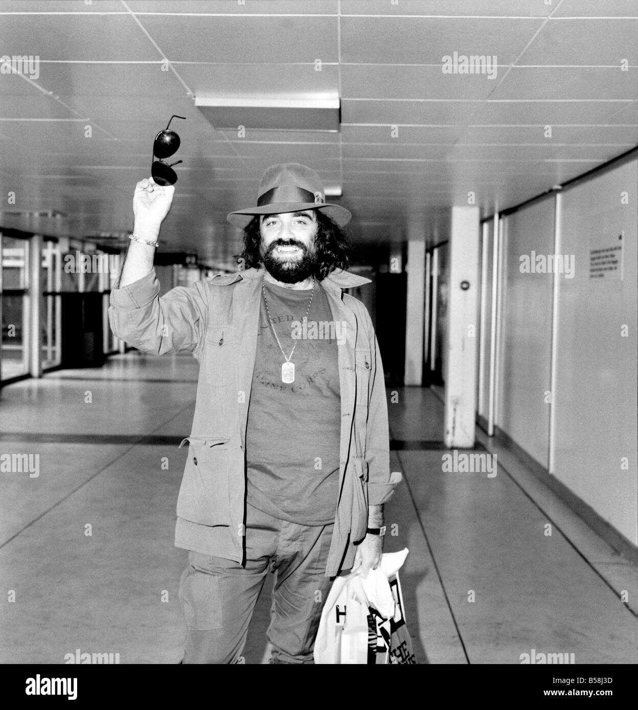 Demis Roussos leaving Heathrow Airport for Abu Dhabi. He is with a show ...