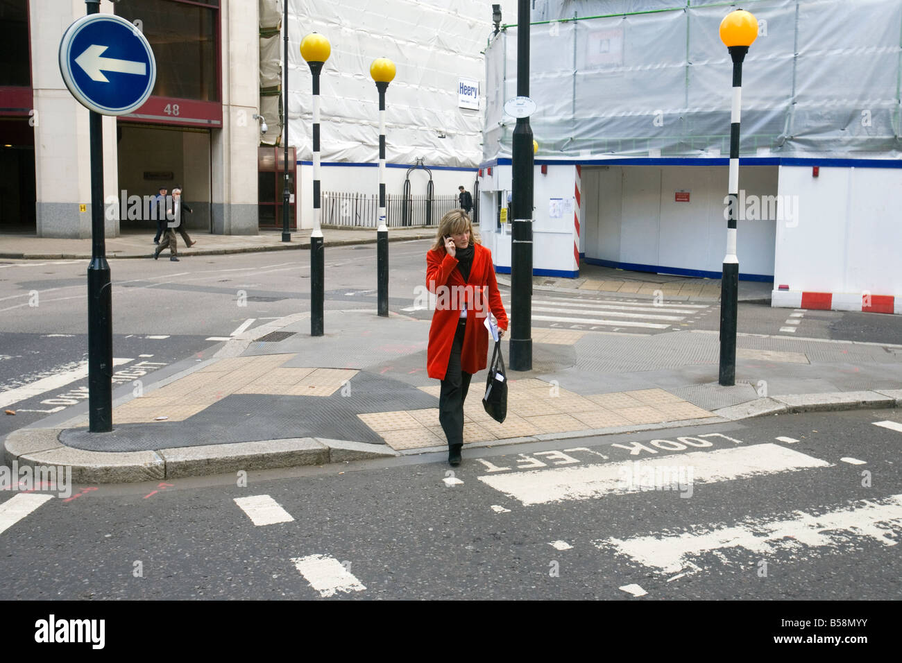 a woman crossing at a zebra pedestrian crossing in london Stock Photo ...