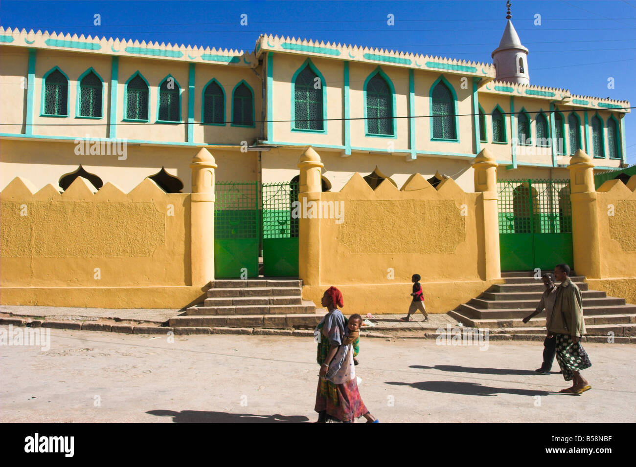 People walking past Jamia Mosque built in the 16th century Old Town ...