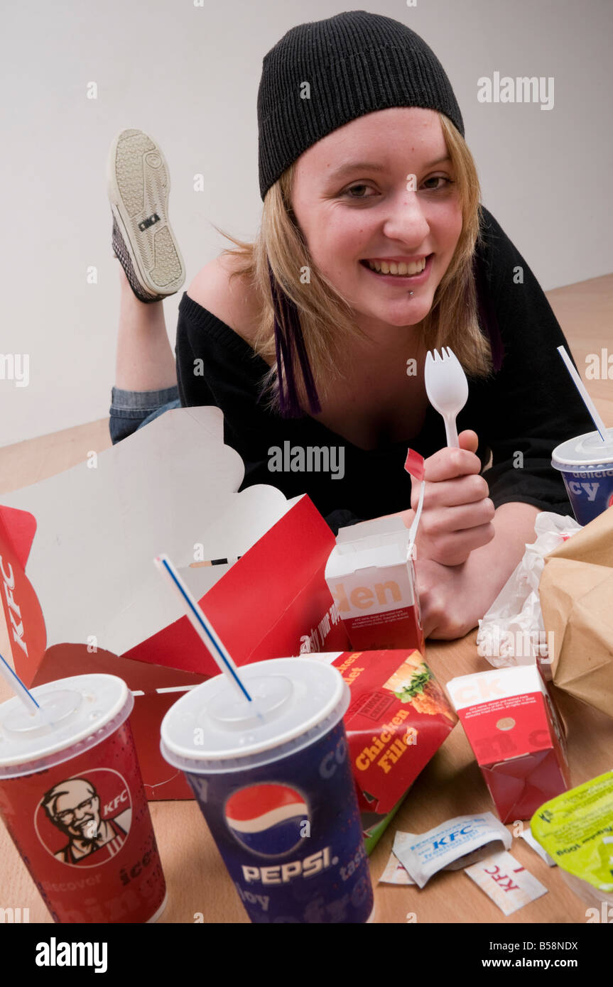 smiling teenage girl with the remains of a Kentucky Fried Chicken take ...