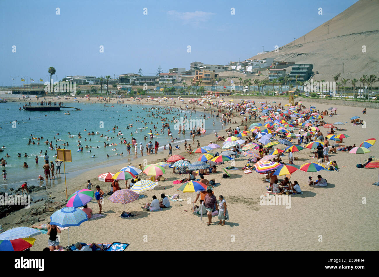 Tourists and holidaymakers crowd the beach at Playa La Lisera in Arica ...