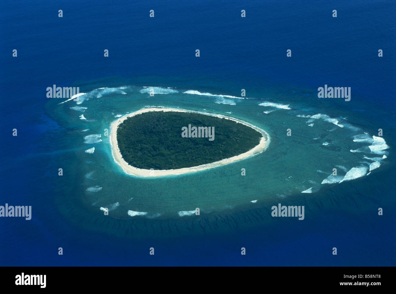 Aerial of reef formation and island in Fiji Pacific L Murray Stock ...