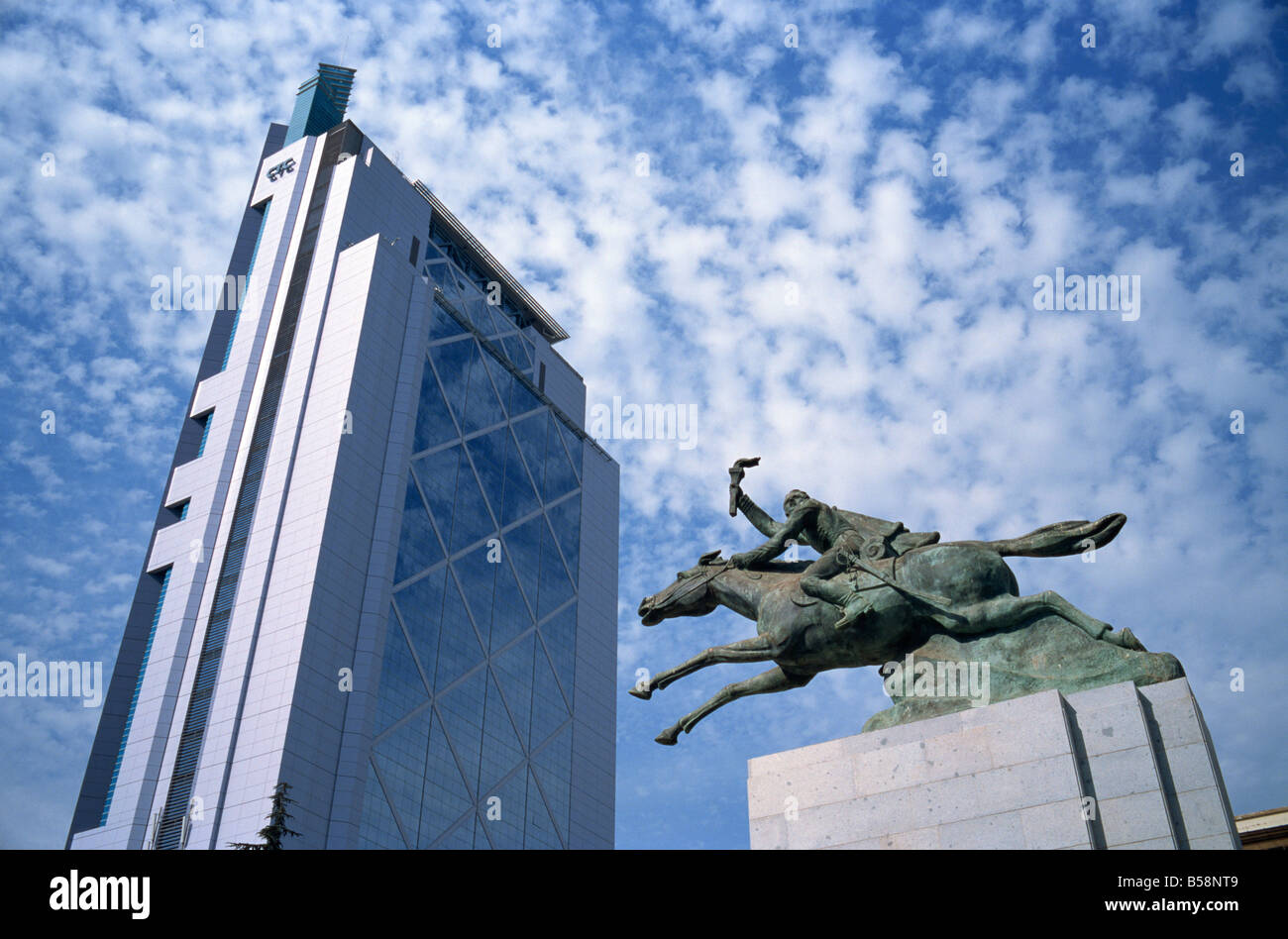 Modern skyscraper and statue show contrast of the old and the new ...