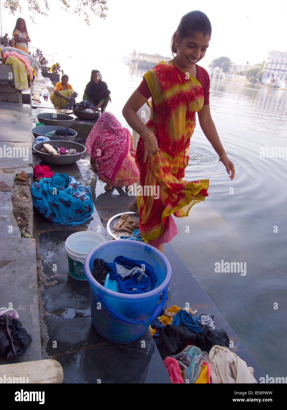 local young beautiful women washing laundry and chatting life style in ...