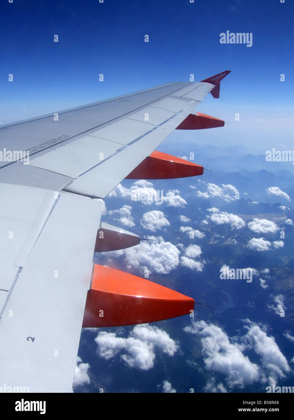 easyjet plane wing in blue sky with clouds Stock Photo - Alamy