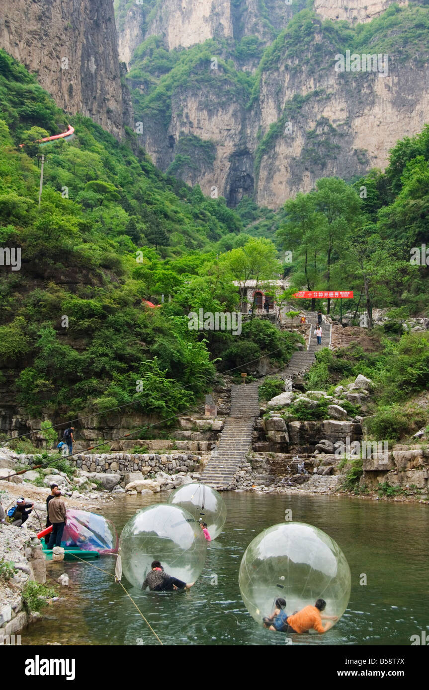 Children playing on river inflatables Wan Xian mountain recreation area ...
