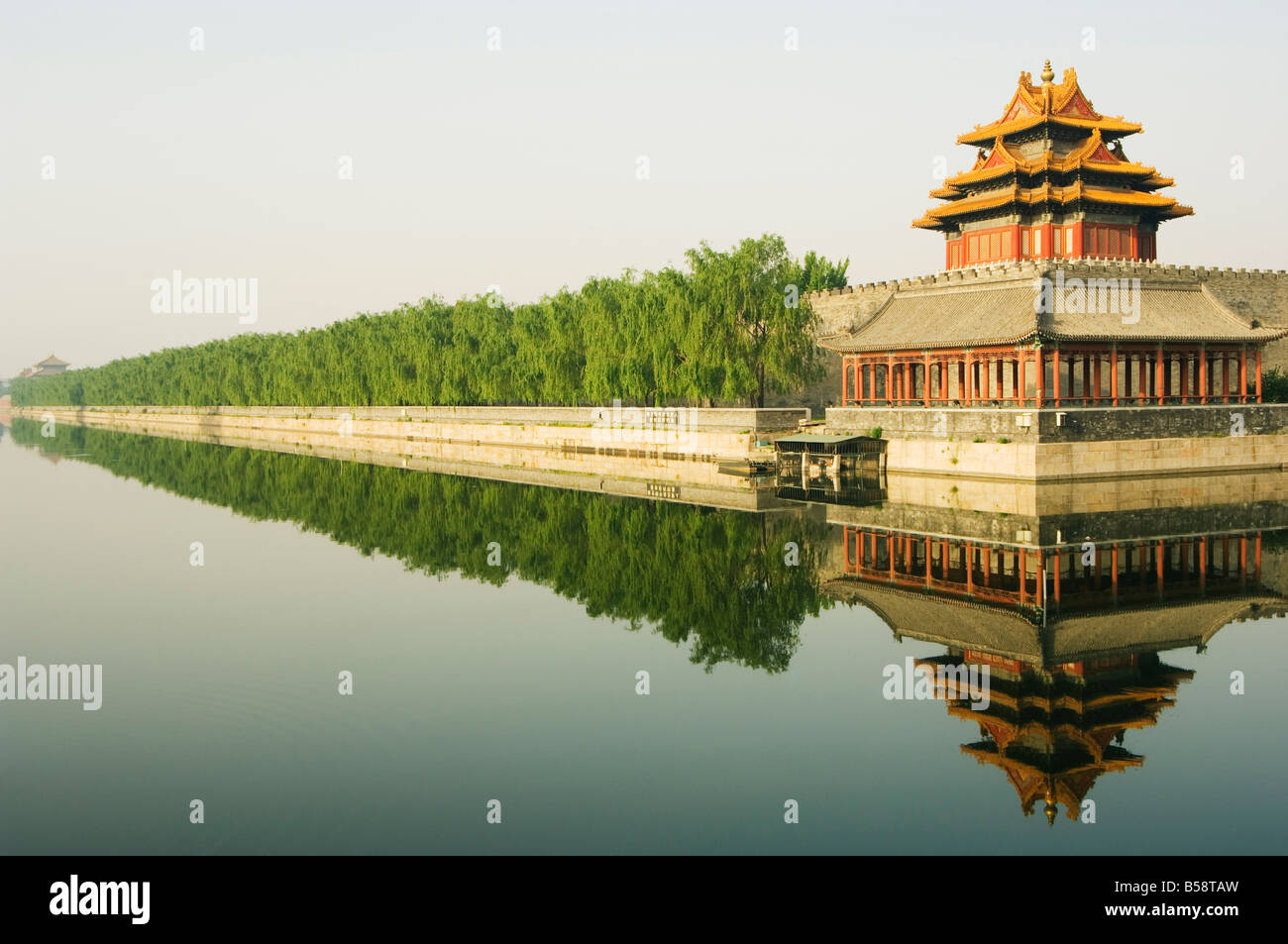 A reflection of the Palace Wall Tower in the moat of The Forbidden City ...