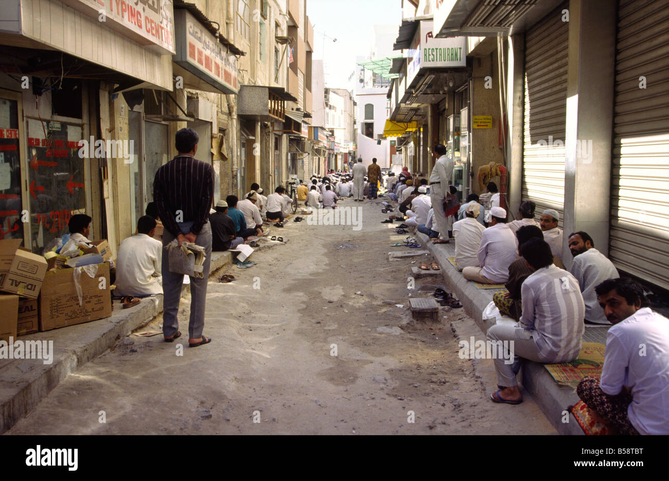 UAE Dubai religion muslim worshippers praying in street outside Mosque ...