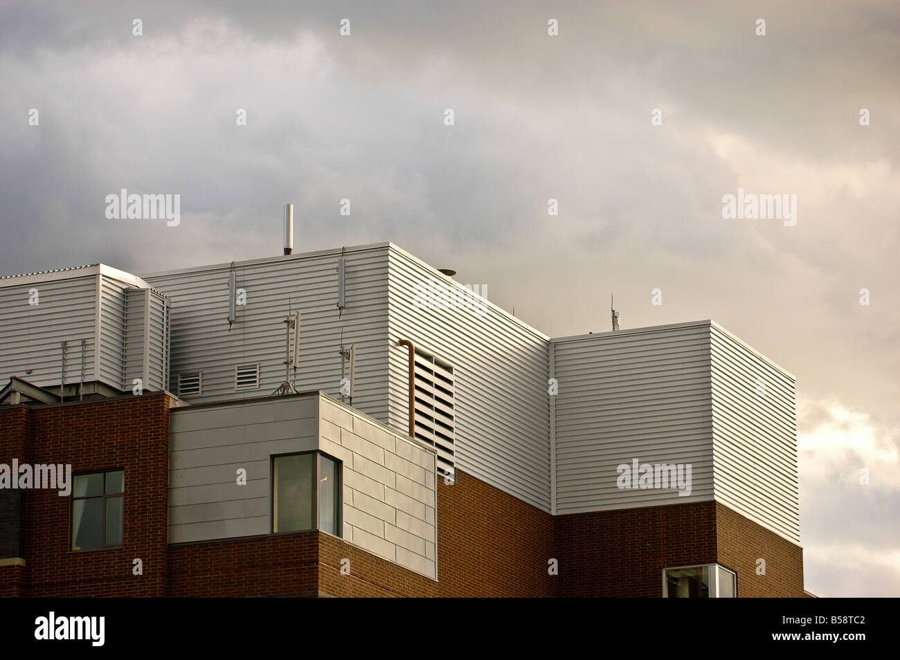 Looming storm clouds pass over a modern building Stock Photo - Alamy