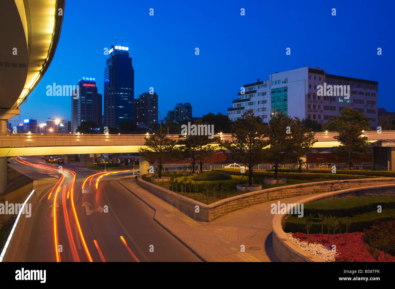 Car light trails and modern buildings near Beijing North Train Station ...