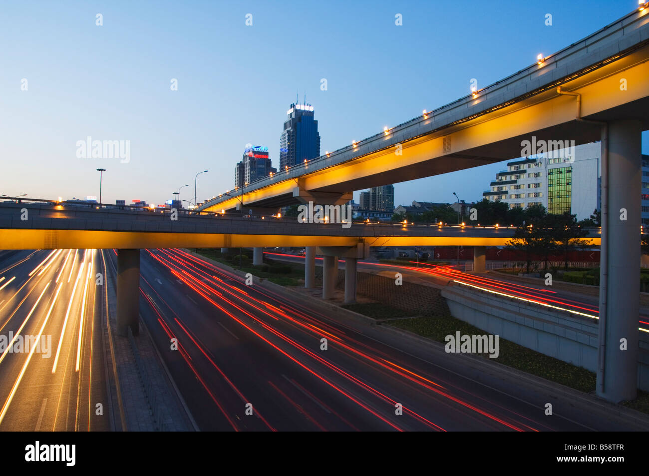 Car light trails and modern buildings near Beijing North Train Station ...
