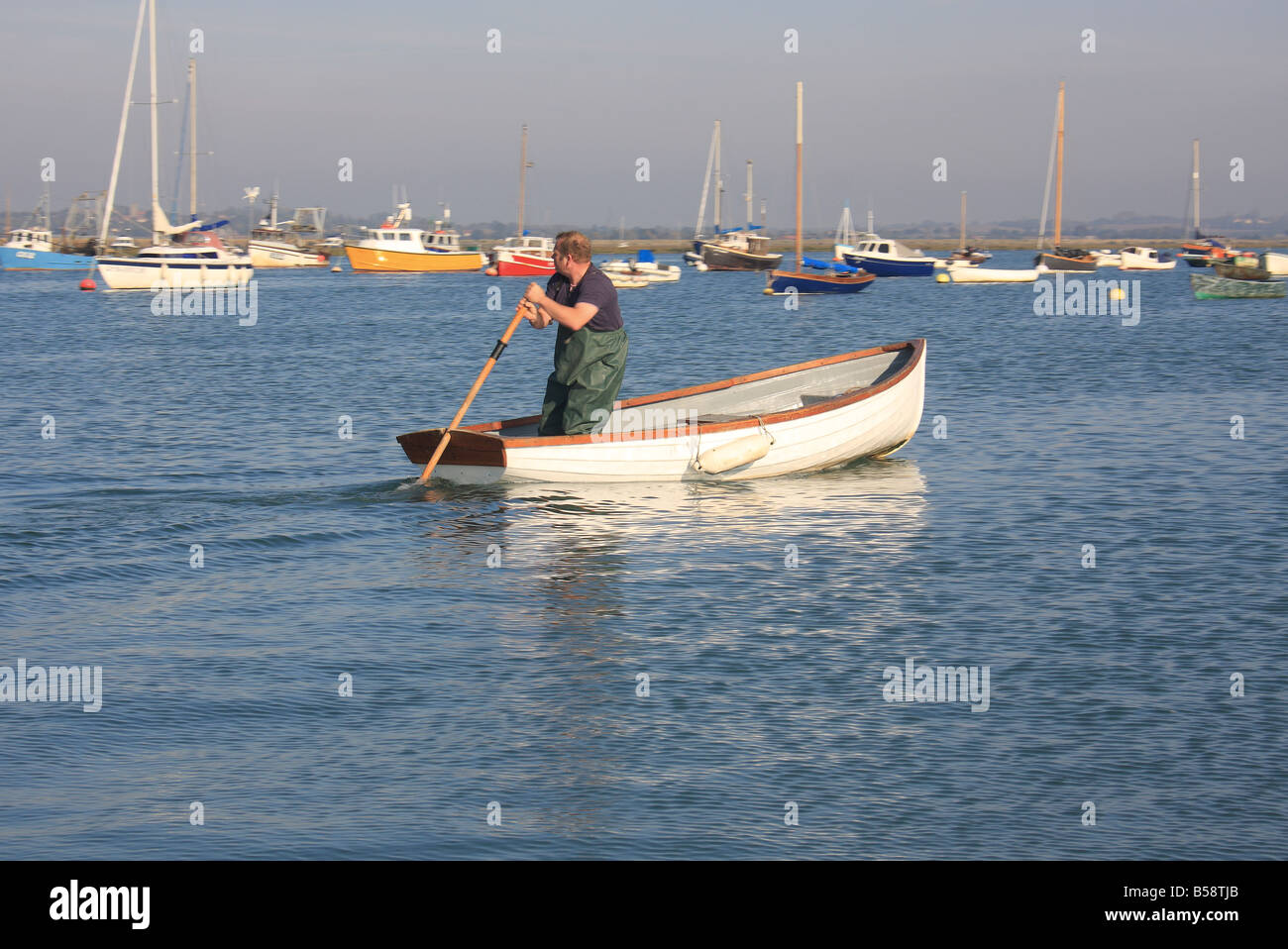 Fisherman rowing boat Stock Photo - Alamy