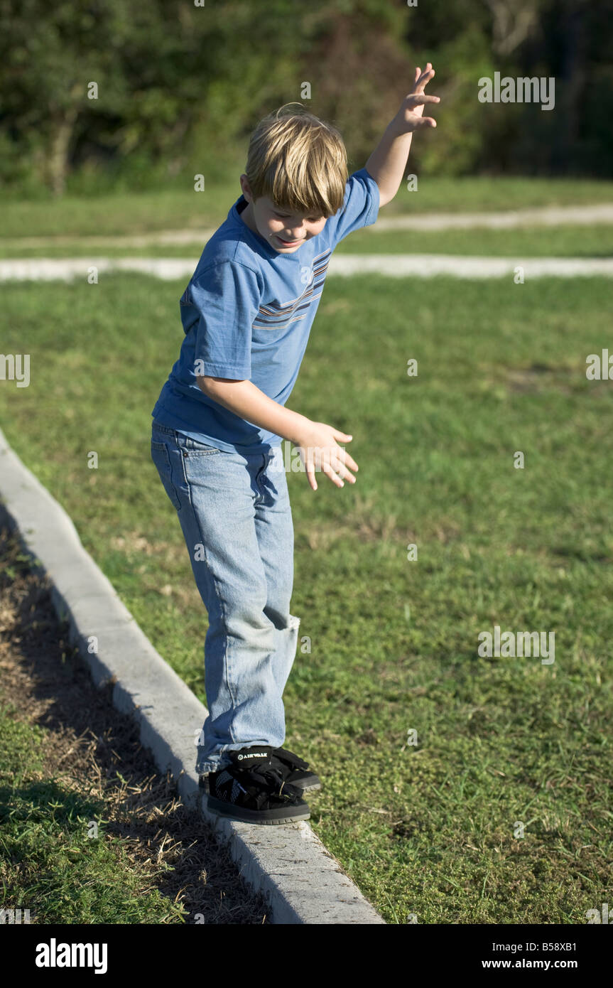 young boy balancing Stock Photo - Alamy