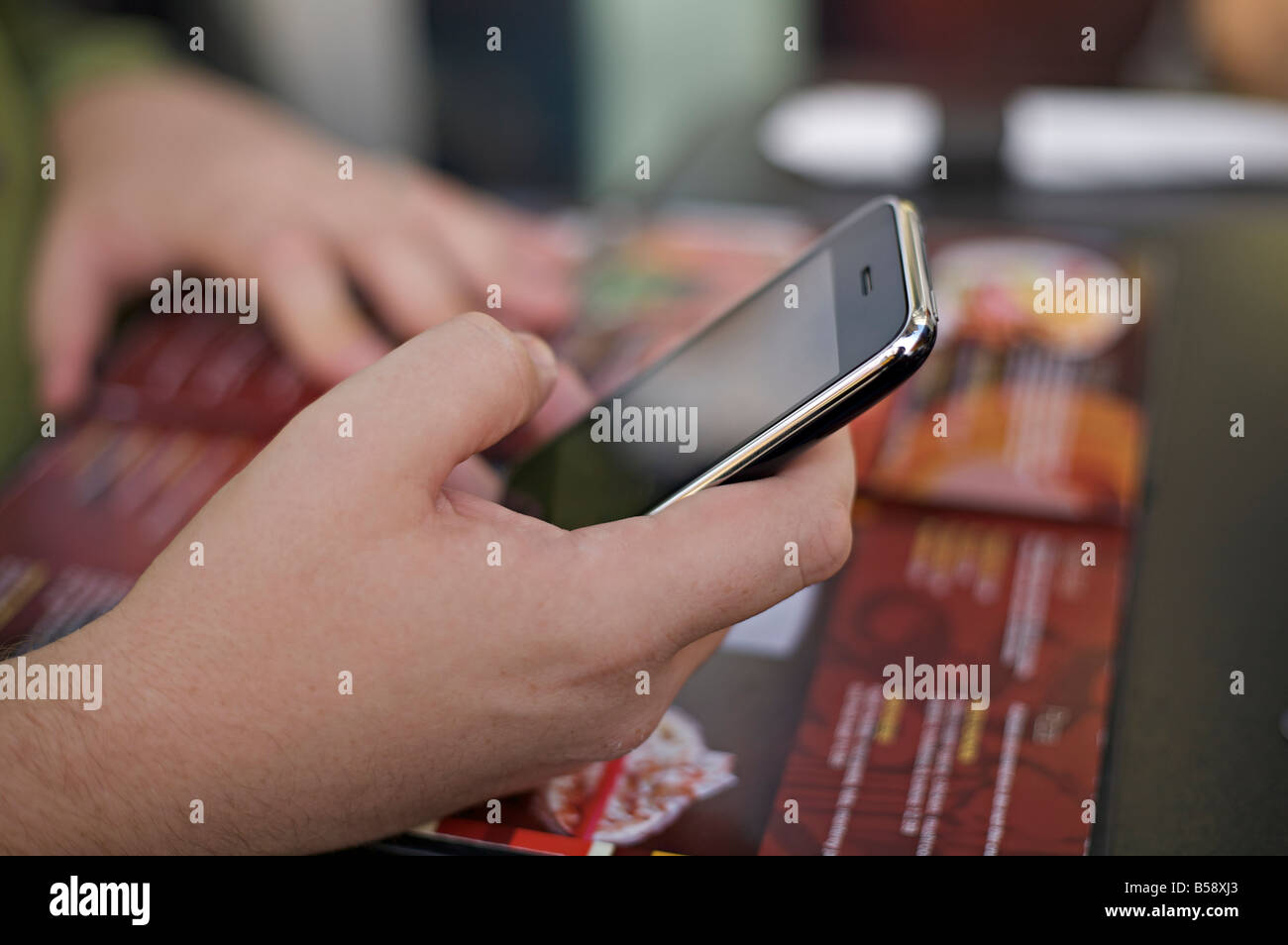 Man hand holding iPhone showing iPhone application Stock Photo - Alamy