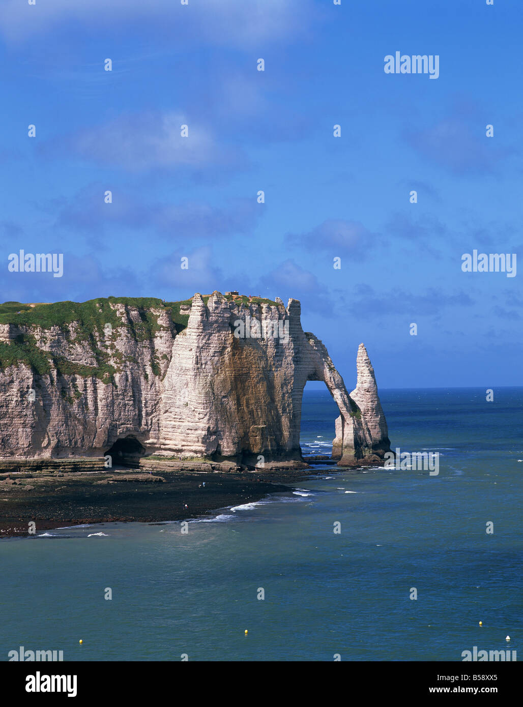 Cliffs and rock arch known as the Falaises on the coast near Etretat ...