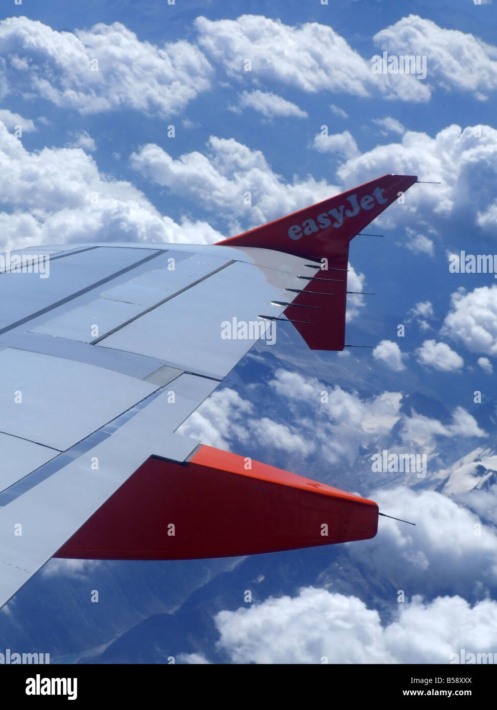 easyjet plane wing in blue sky with clouds Stock Photo - Alamy