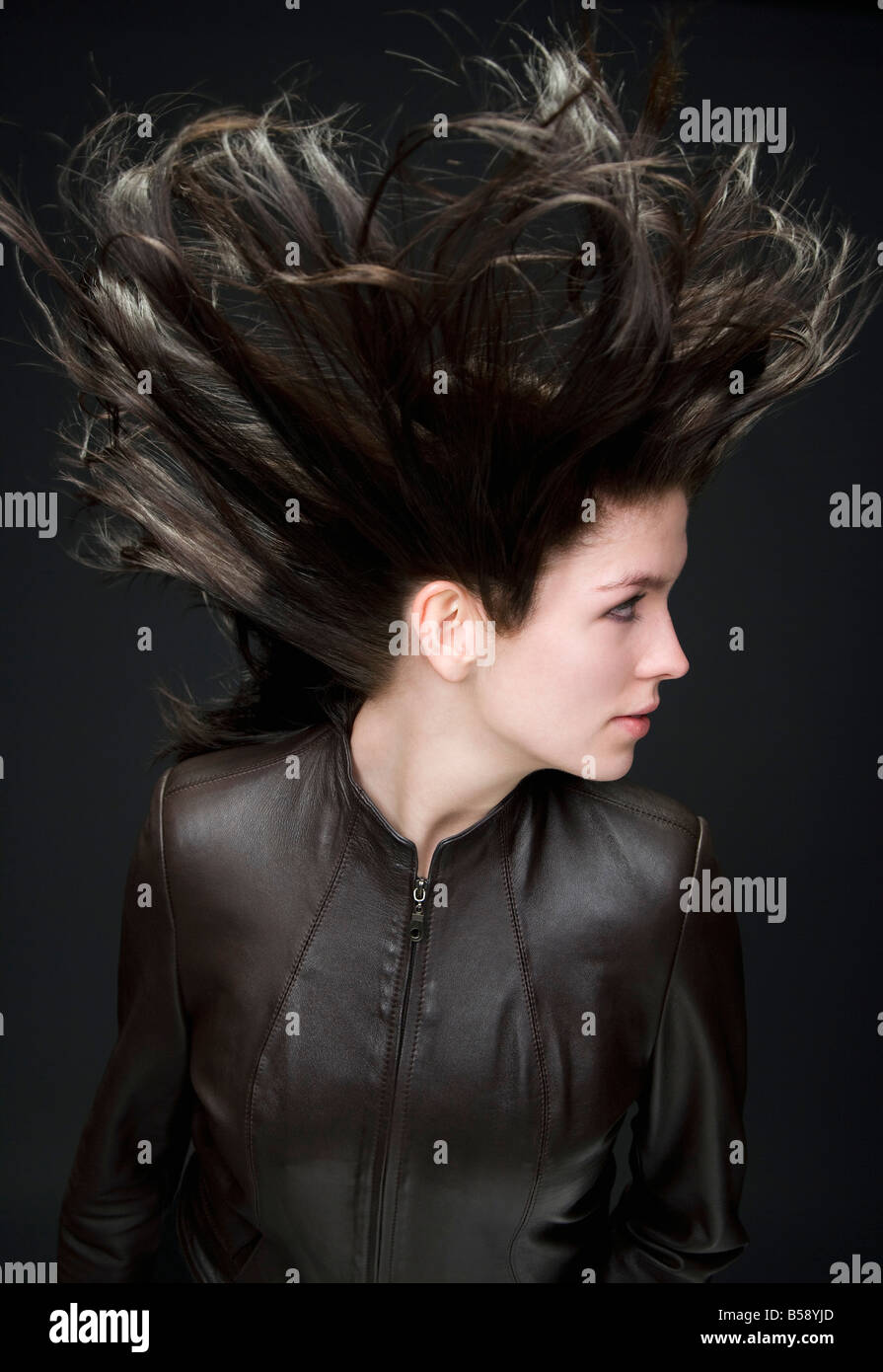 Woman with wind blown hair Stock Photo - Alamy