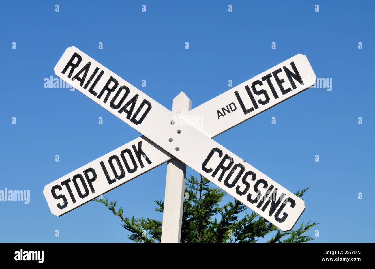 Railroad crossing stop look and listen sign white with black letters ...