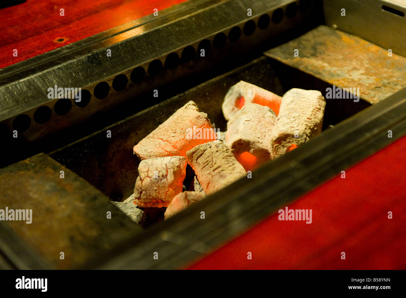 Hot cooking coals in a Yakitori restaurant in the Shibuya district in ...