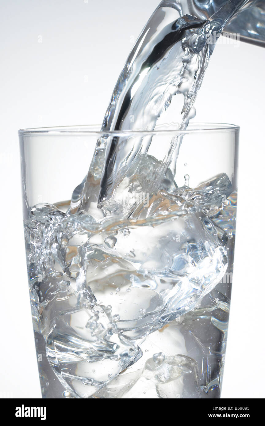 Pouring water into glass Stock Photo - Alamy