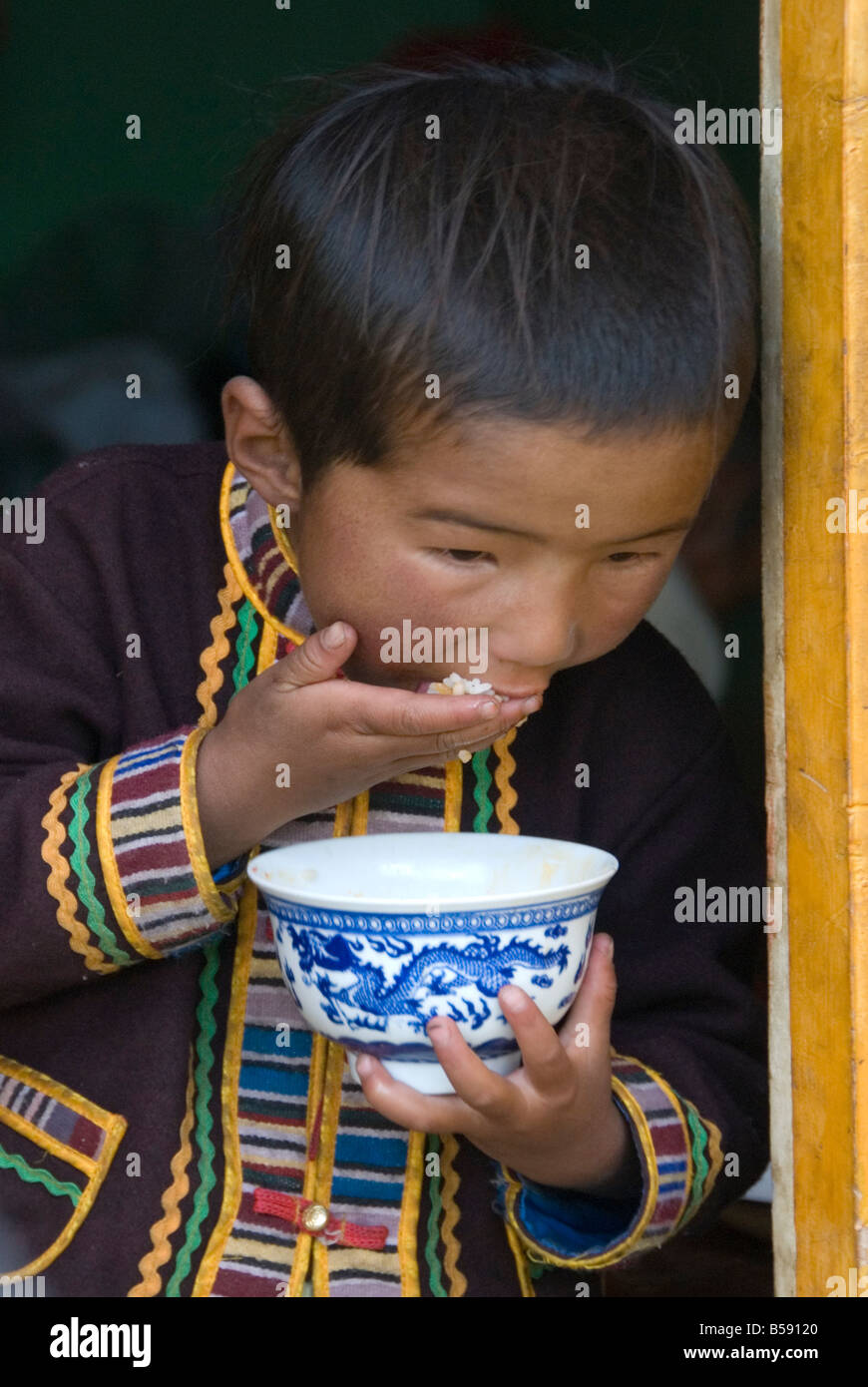 Child eating bowl of rice hi-res stock photography and images - Alamy