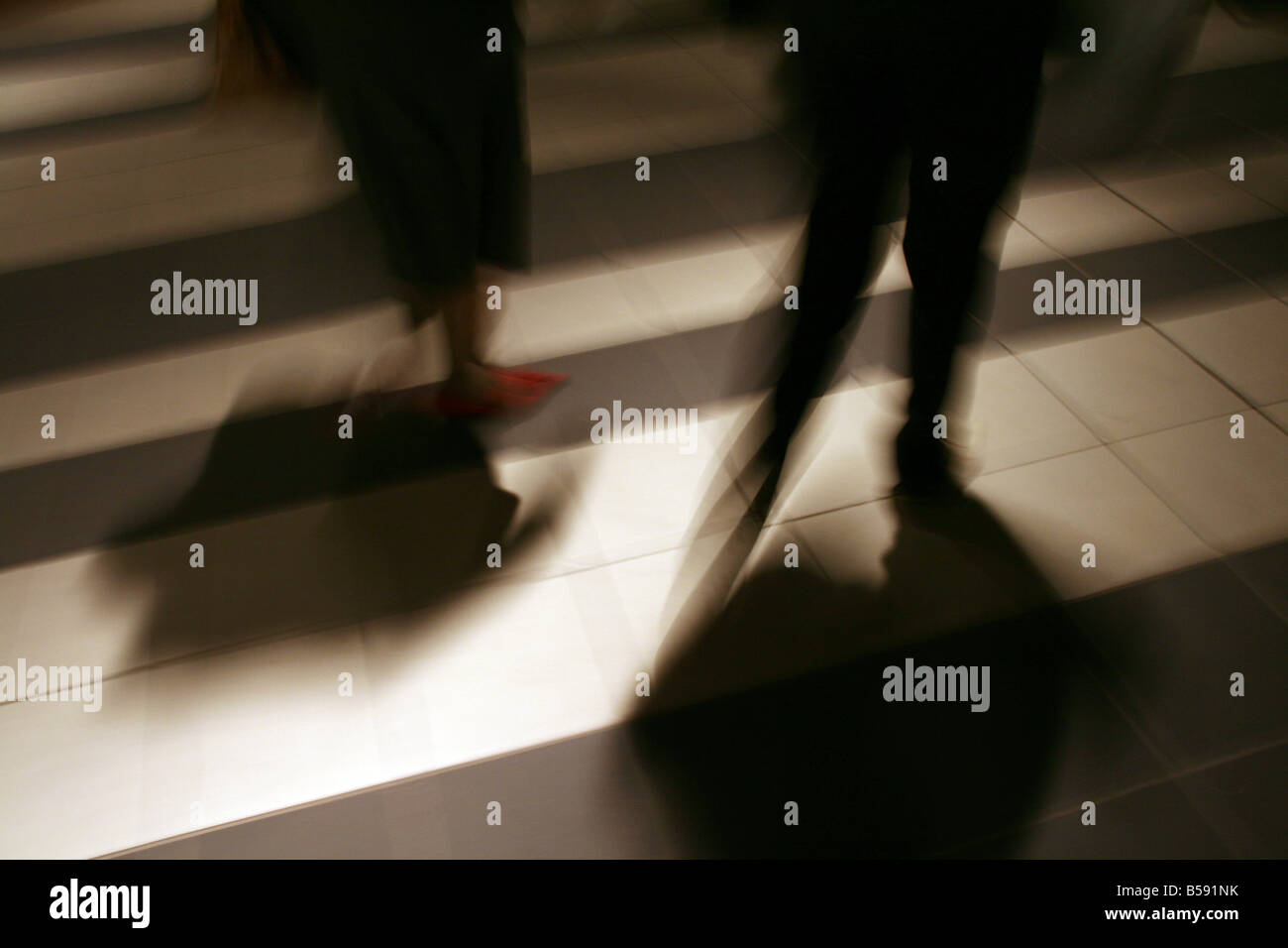 detail of people legs walking fast in street at night Stock Photo - Alamy
