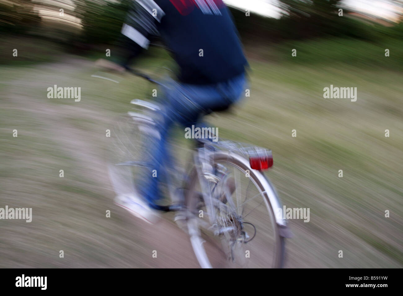 person riding fast bike on rural street road Stock Photo - Alamy