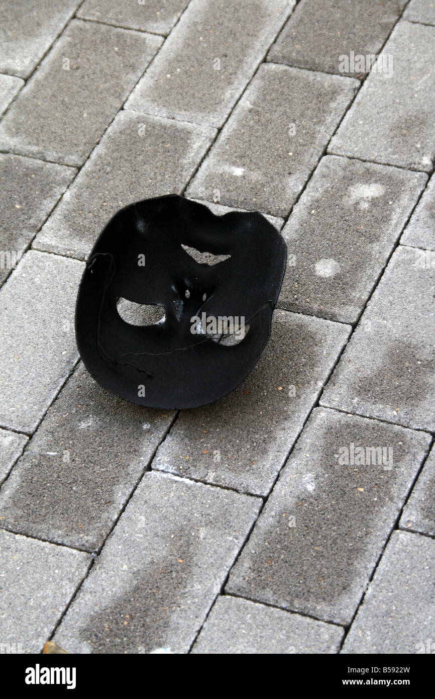 one black full face mask left on floor in street Stock Photo - Alamy