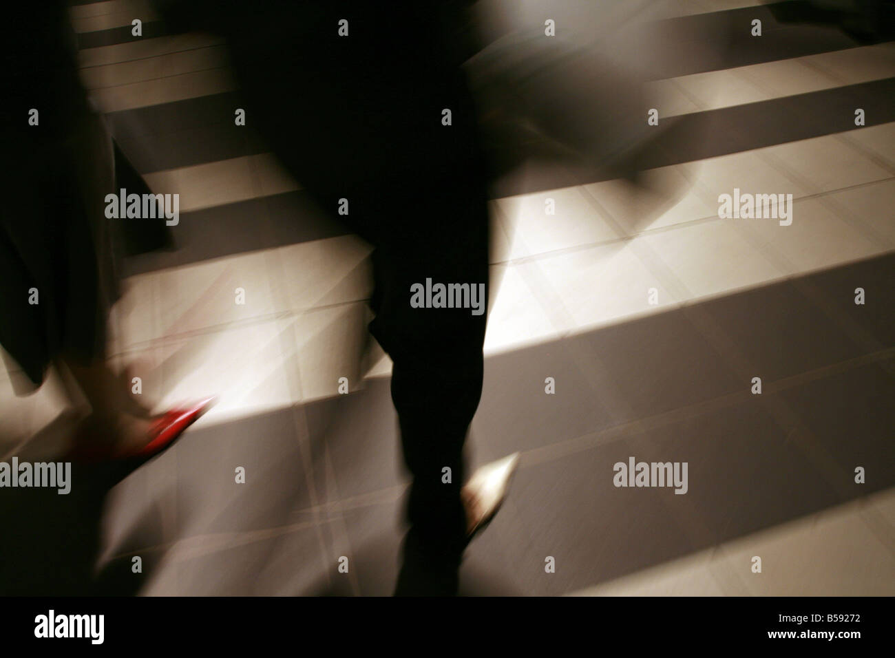 detail of people legs walking fast in street at night Stock Photo - Alamy