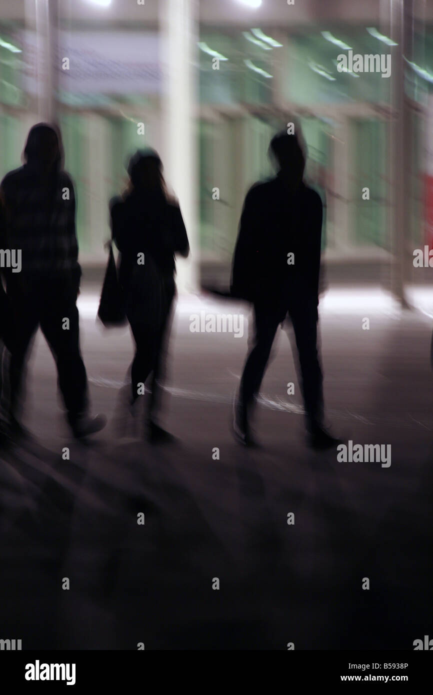 three people walking in street at night Stock Photo - Alamy