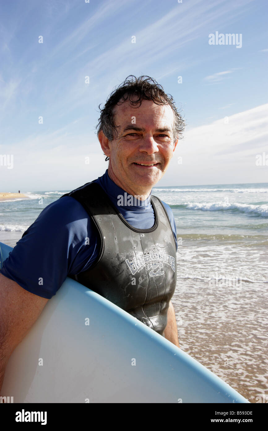 PORTRAIT OF A 50 SOMETHING MALE EMERGING FROM THE SURF VERTICAL ...