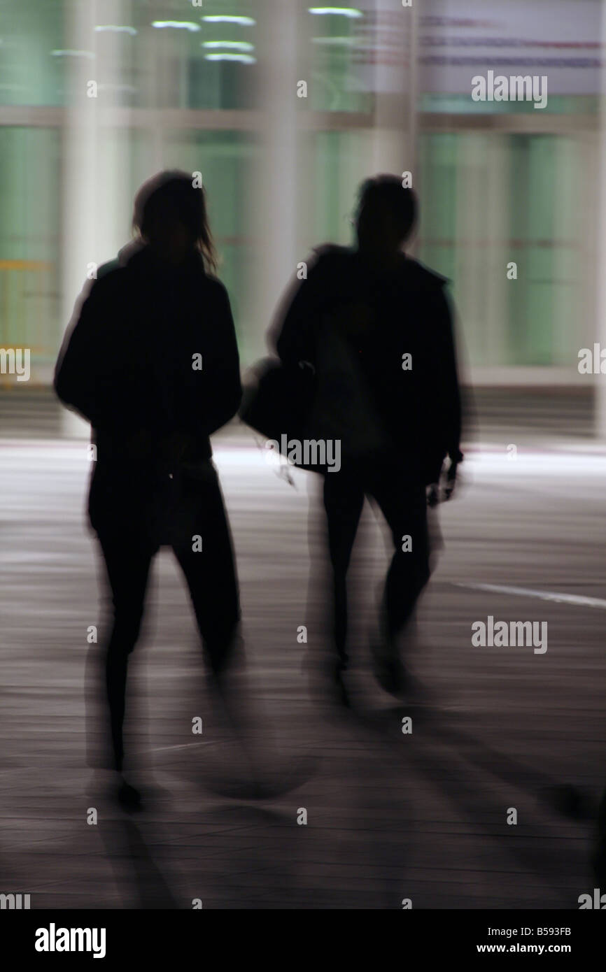 Two People Walking In The Street