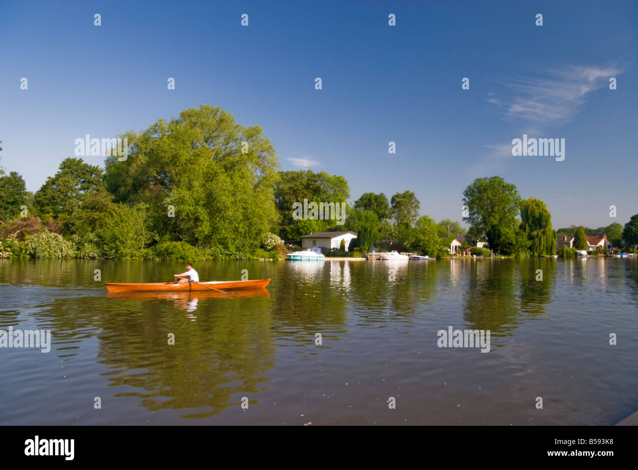 Rowing a traditional wooden skiff on the River Thames near Walton on ...