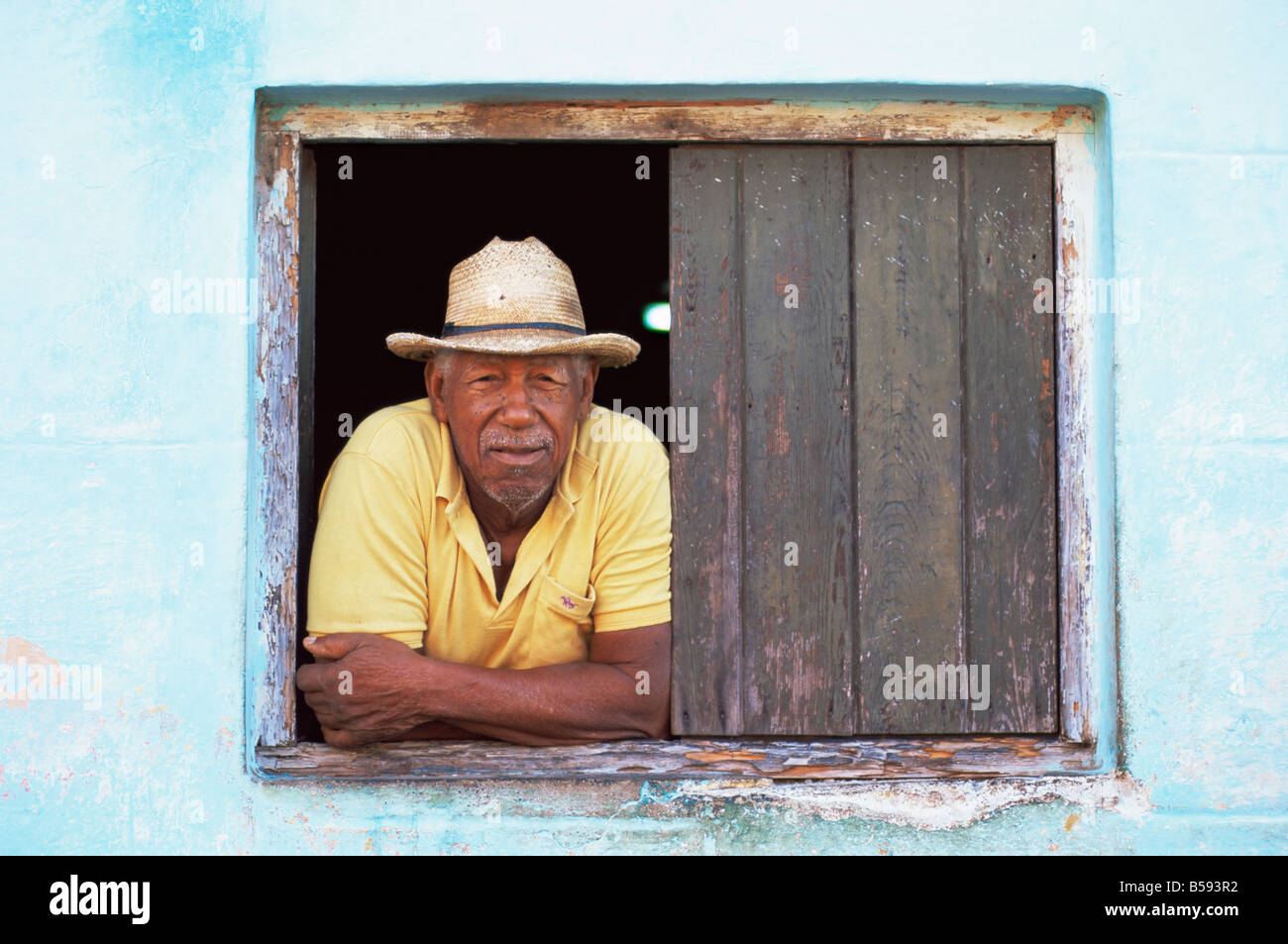 Man leaning out of the window of his house Trinidad Cuba West Indies ...