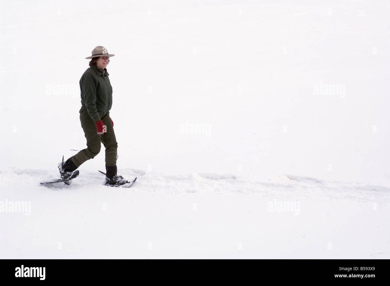National Park service ranger leads a snow shoe hike across a snow ...