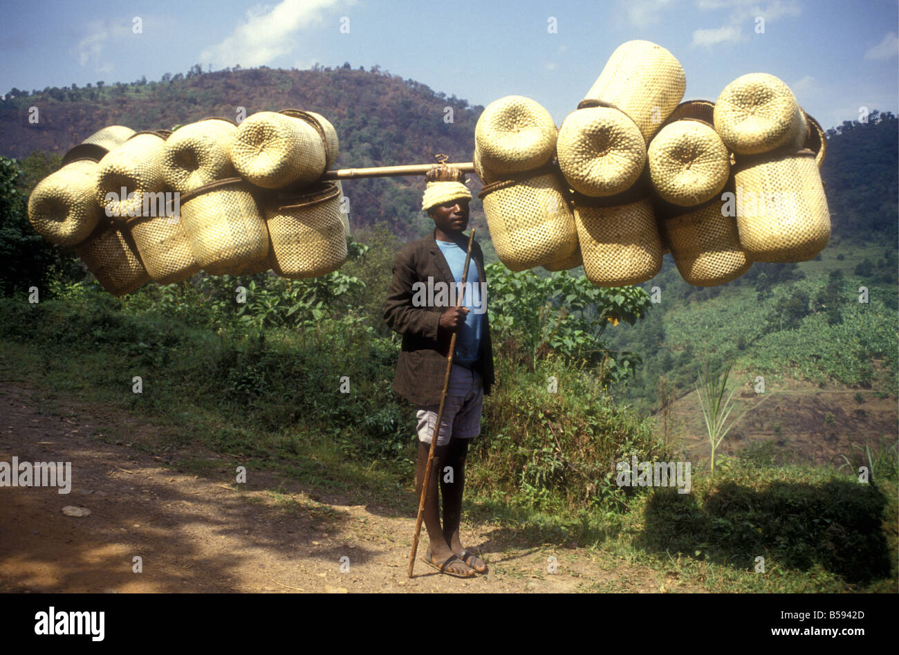 Man carrying baskets to market in South West Uganda Stock Photo - Alamy