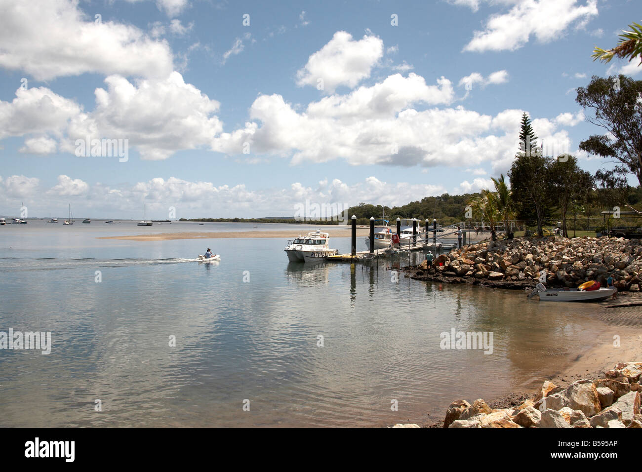 Boats in sea with pier by One Mile Beach near Dunwich on North ...