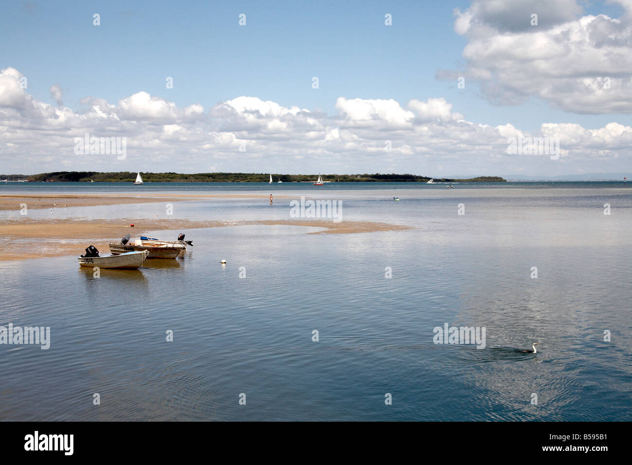 Boats and bird in sea by One Mile Beach near Dunwich on North ...