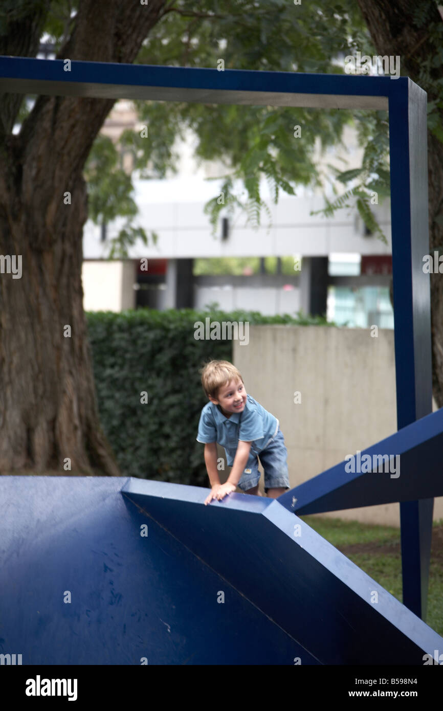 young boy child climbing sculpture in Brisbane Queensland QLD Australia ...