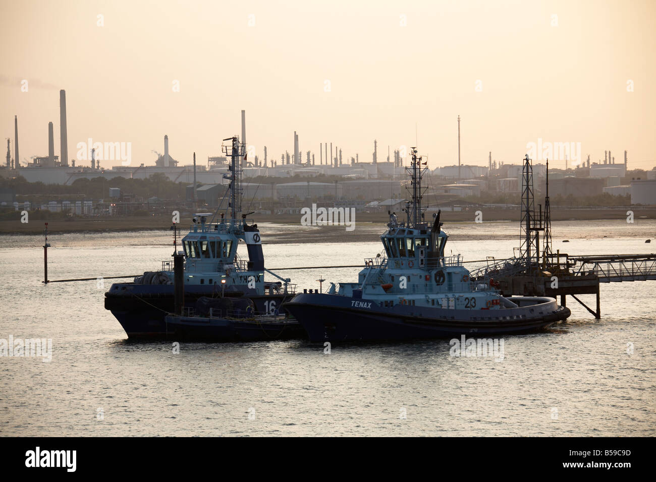 Merchant shipping tug boat vessel ships docked at Fawley oil refinery ...
