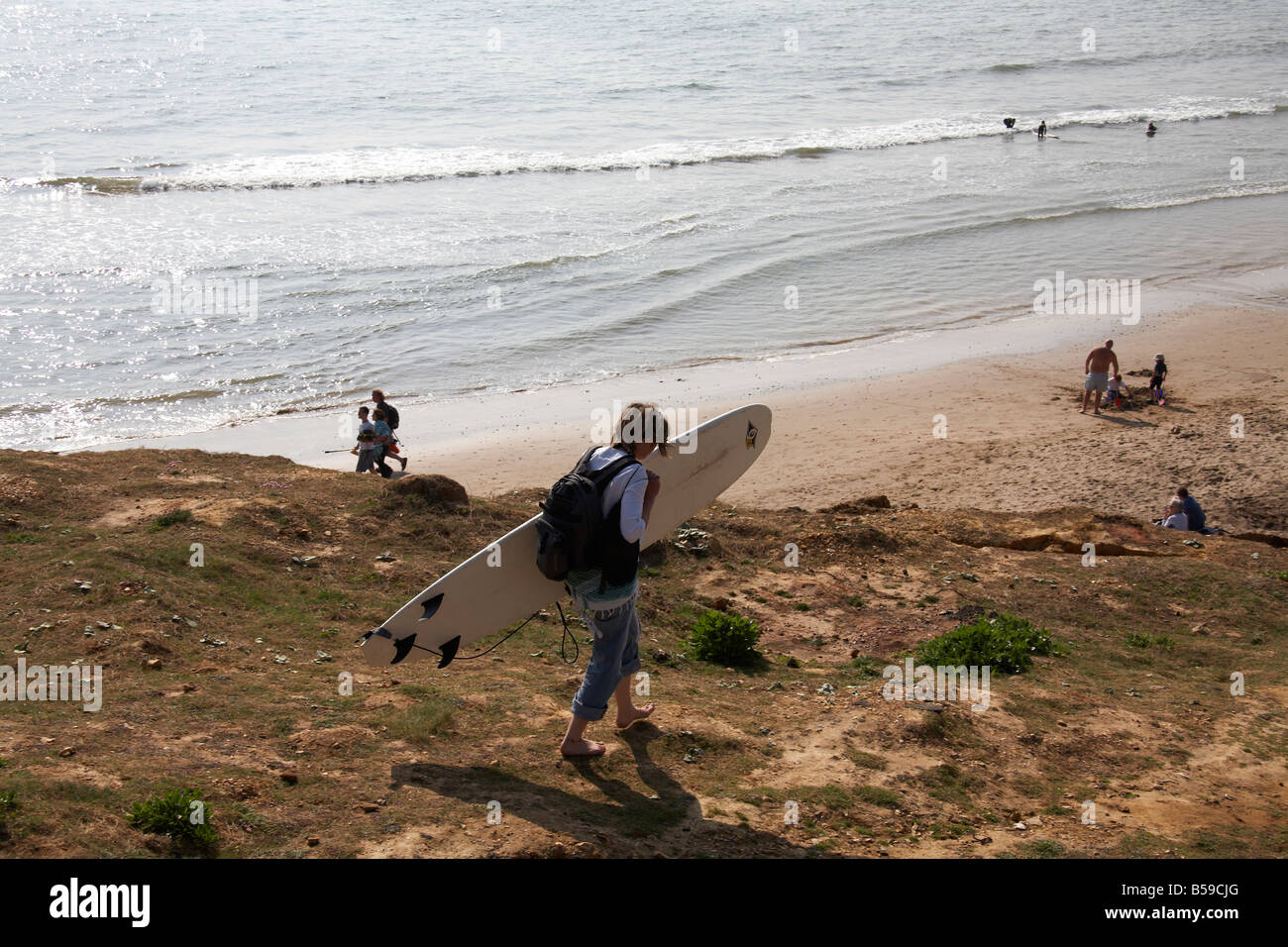 People sunbathing and swimming on Brightstone Bay sea beach with south ...