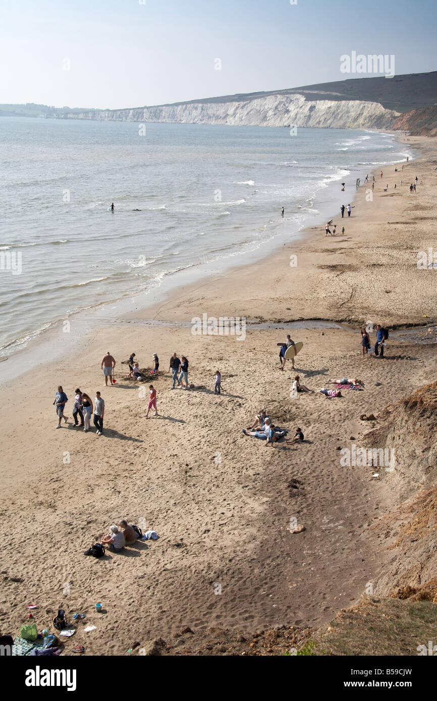 People sunbathing and swimming on Brightstone Bay sea beach with south ...