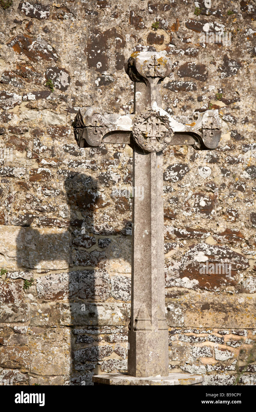 Stone carved cross in graveyard of Church of St Peter and St Paul on a ...