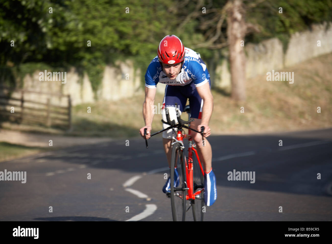 Racing tandem cyclists on bicycle road race climbing hill through ...