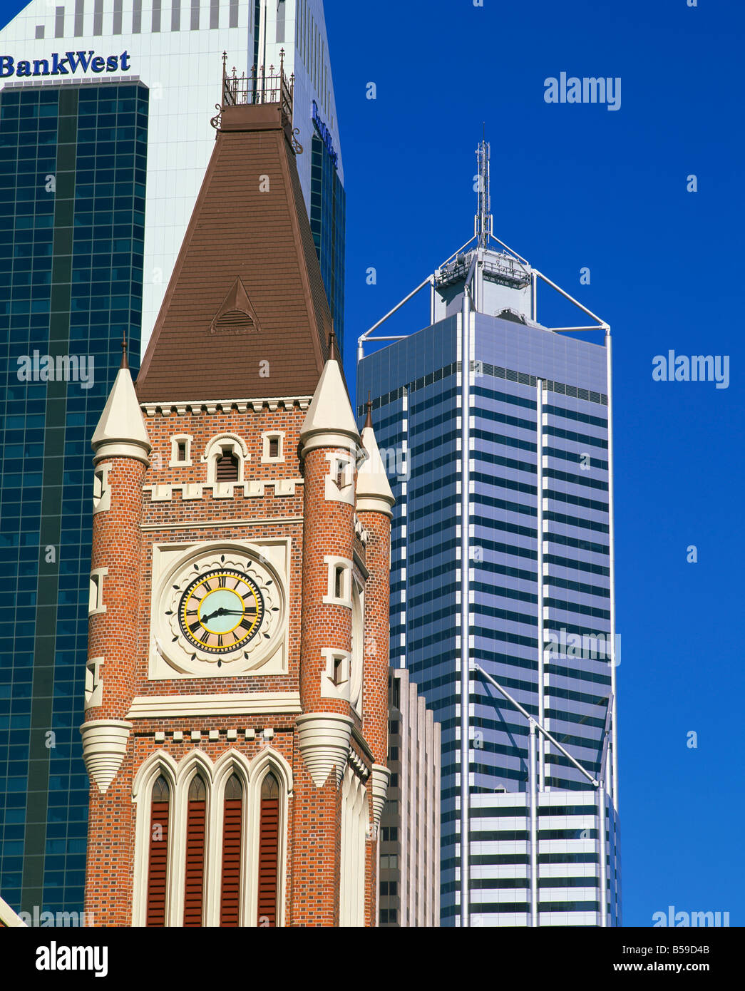 Old clock tower contrasts with new modern office blocks in the city of ...