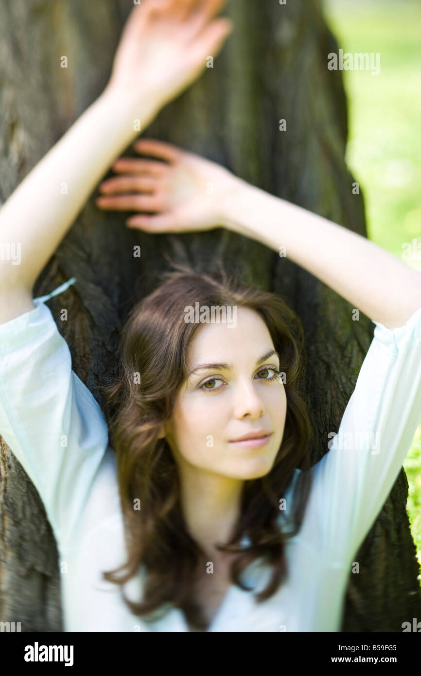 young woman relaxing under tree Stock Photo - Alamy