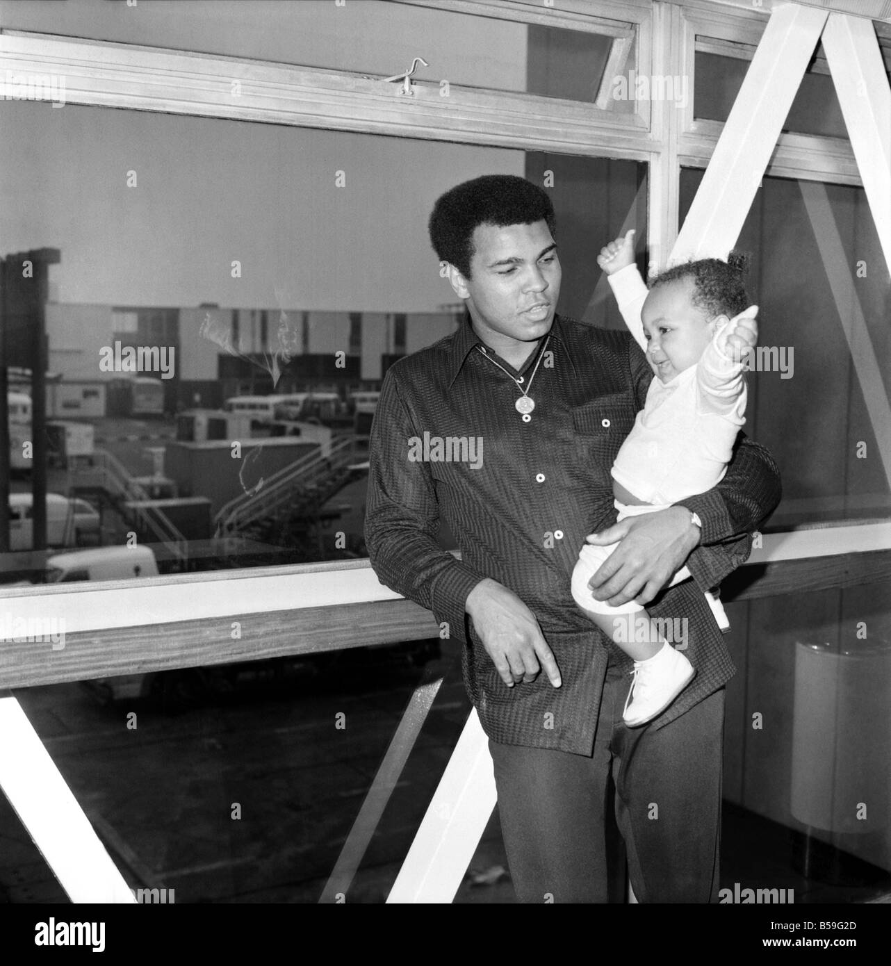 Mohammad Ali with baby Hanna at Heathrow Airport today. August 1977 77 ...