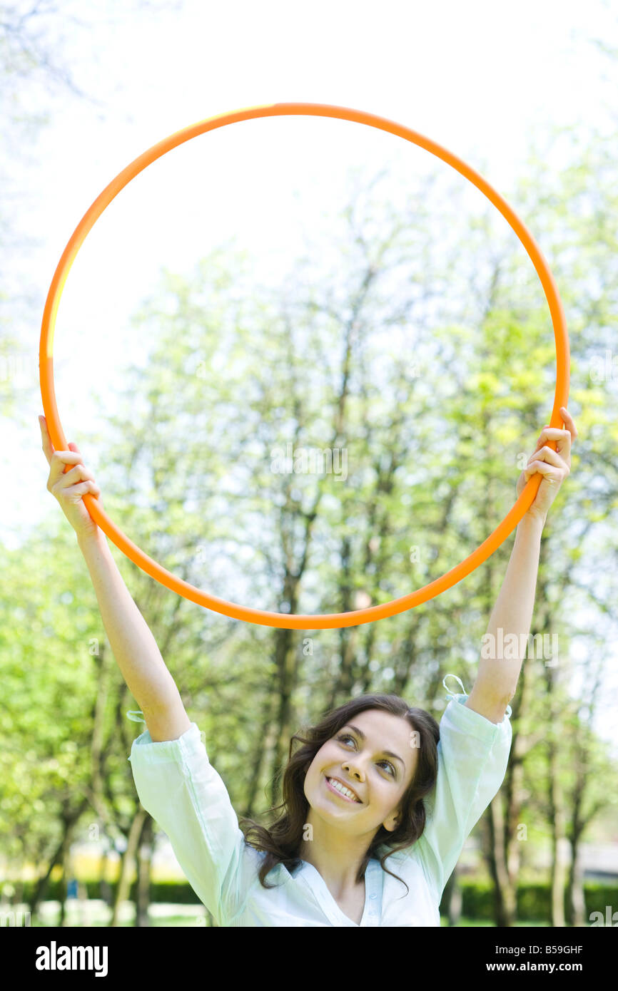 young woman training with hula hoop in park Stock Photo - Alamy